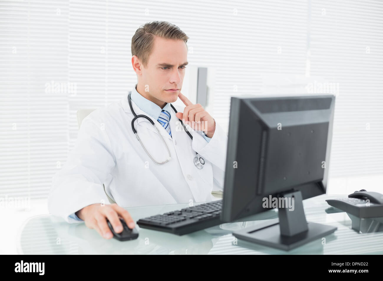 Doctor using computer at medical office Stock Photo - Alamy