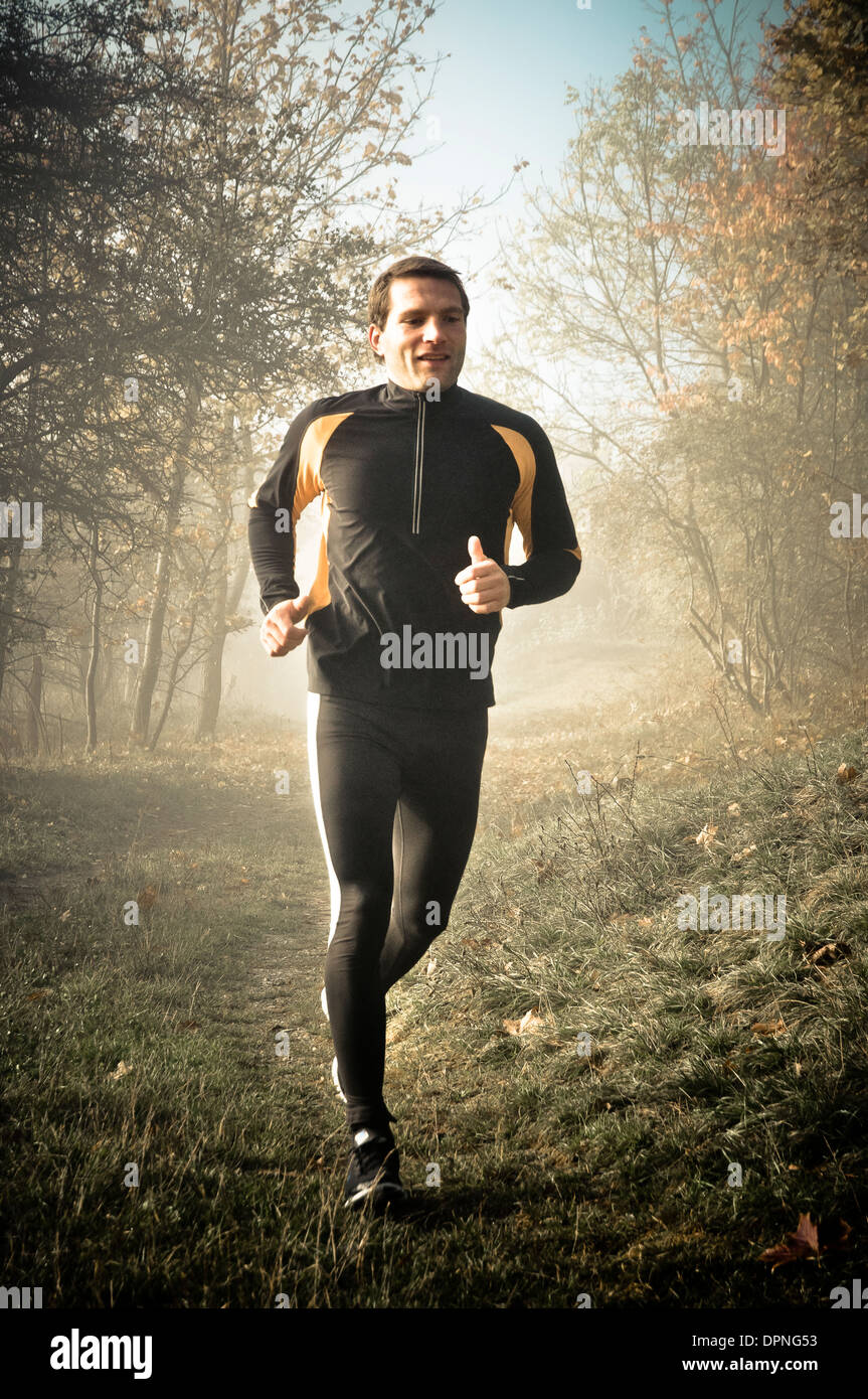 Man running through the forest Stock Photo - Alamy