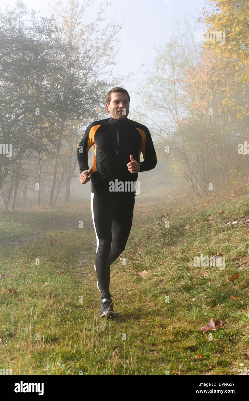 Man running through the forest Stock Photo - Alamy