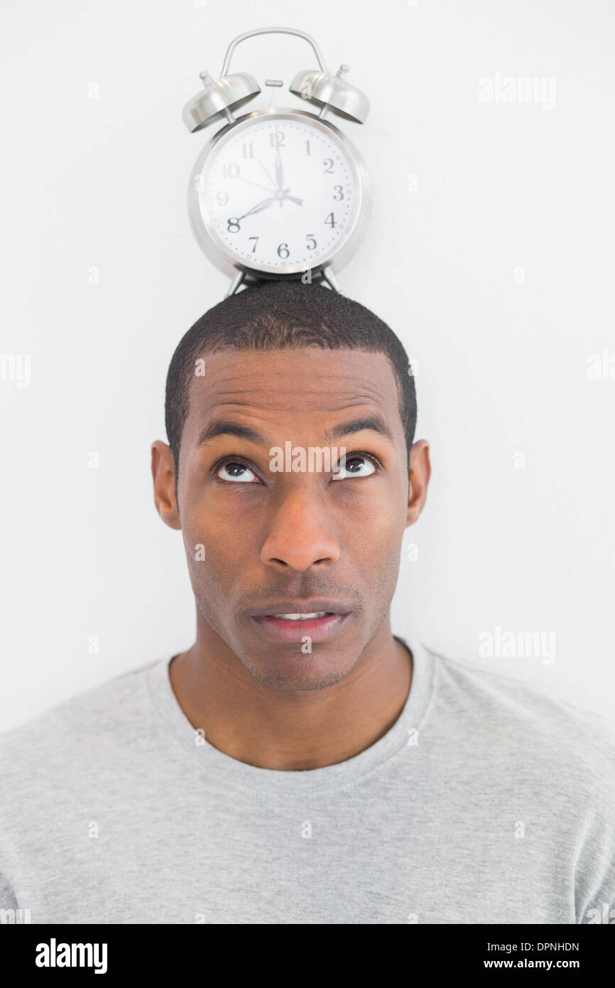 Close up of a man with an alarm clock on top of his head Stock Photo ...