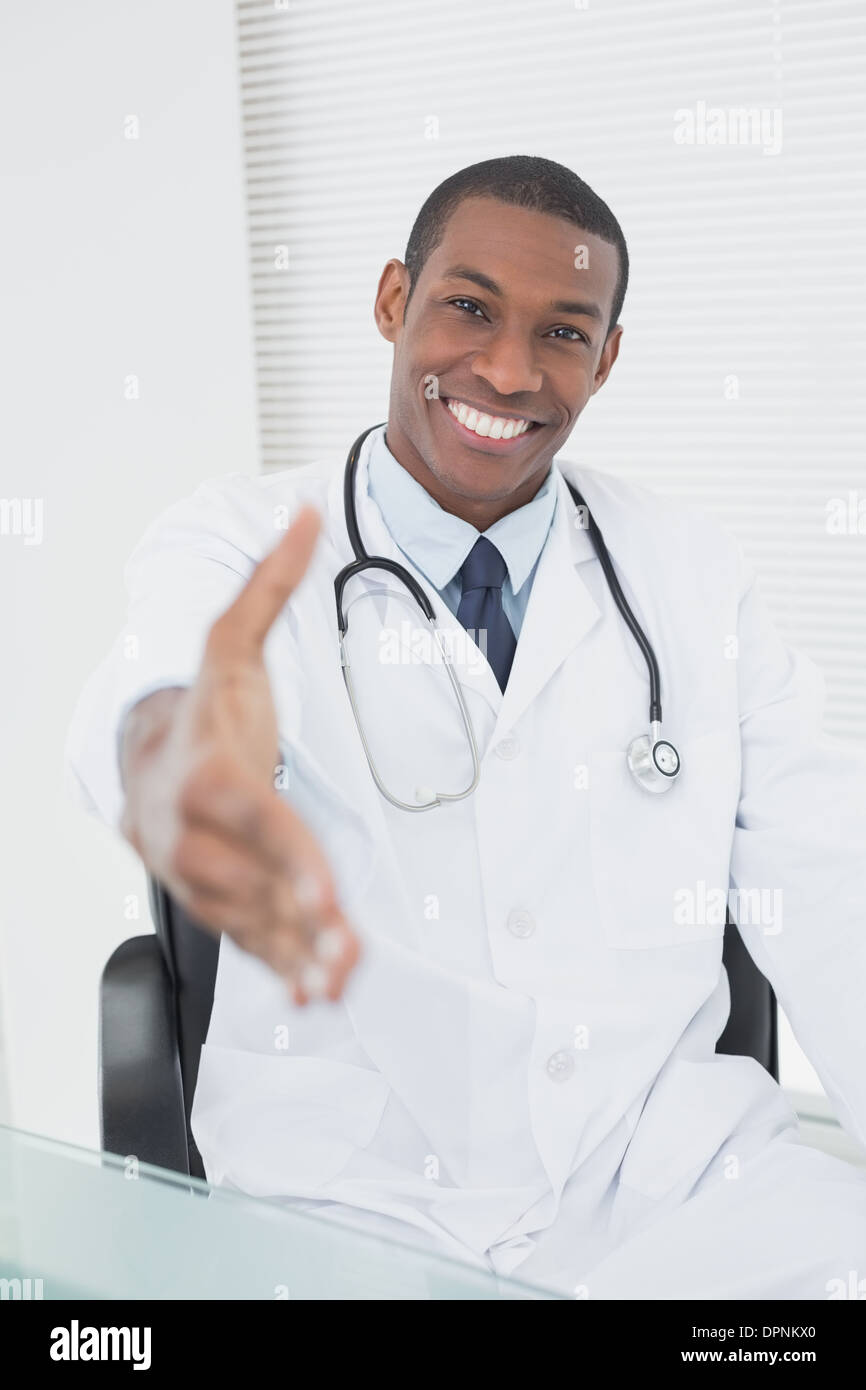 Doctor offering a handshake at medical office Stock Photo - Alamy
