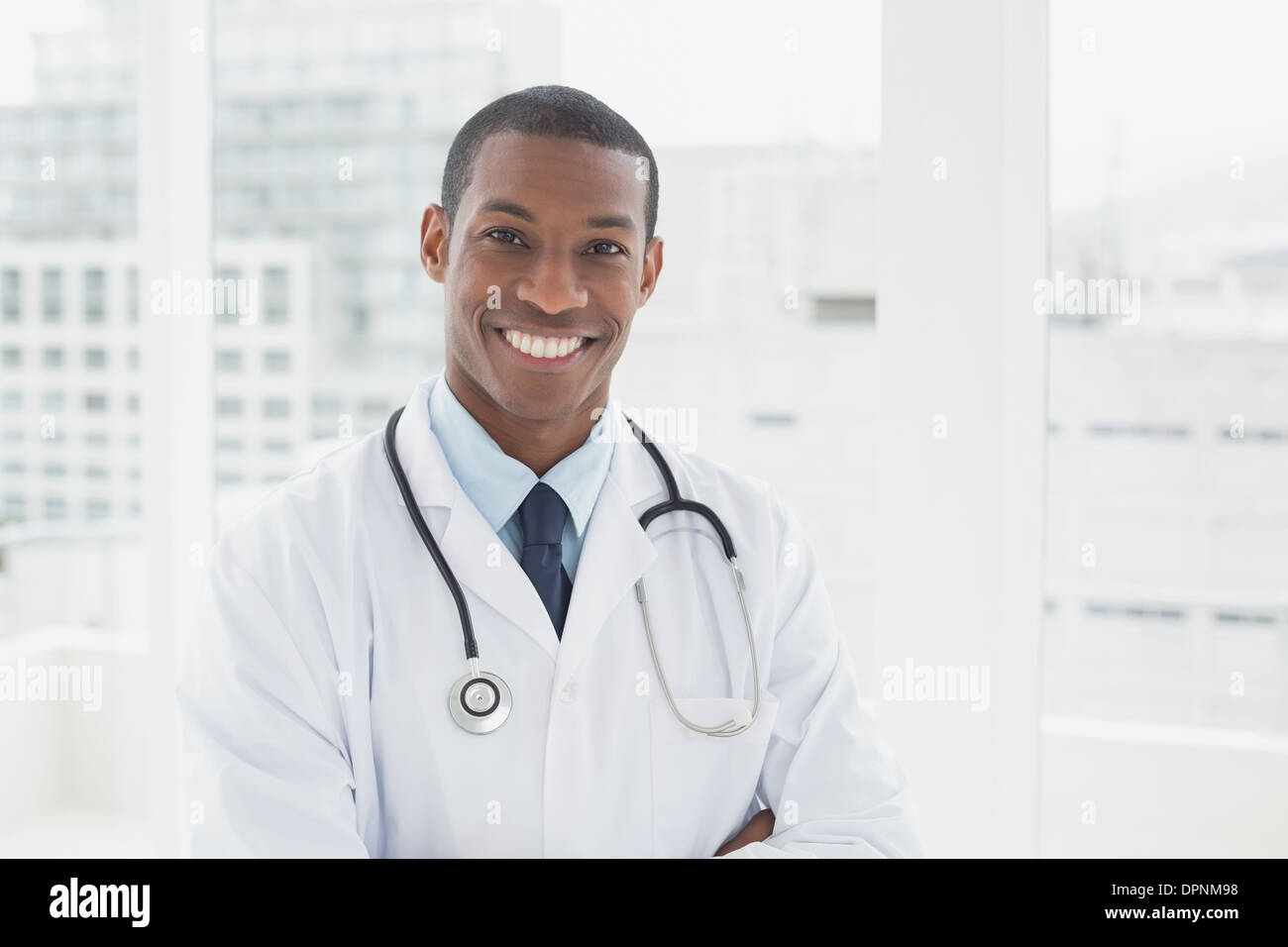 Confident smiling male doctor in a medical office Stock Photo - Alamy