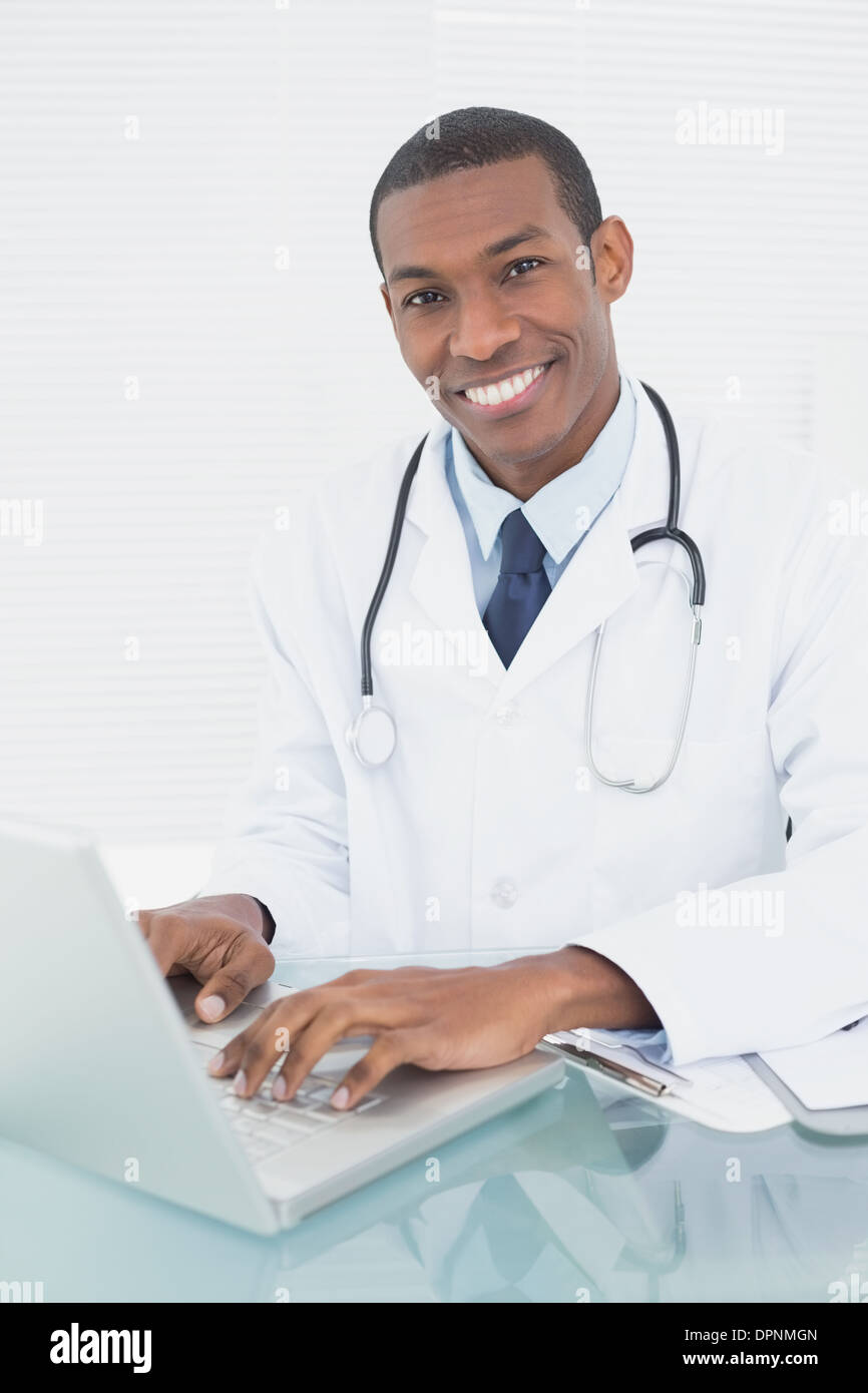 Doctor looking camera using laptop hi-res stock photography and images ...