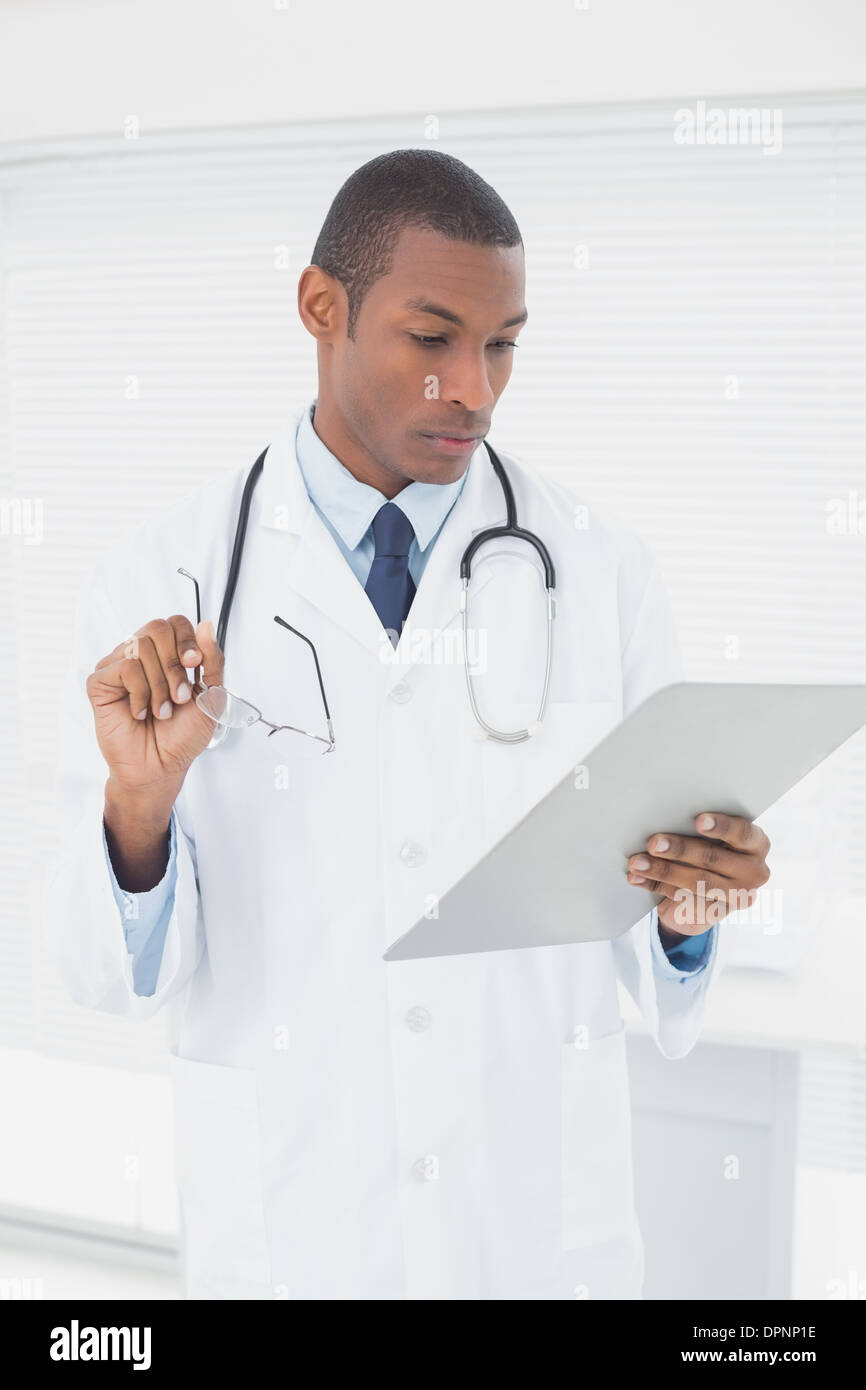 Serious male doctor writing a prescription Stock Photo - Alamy