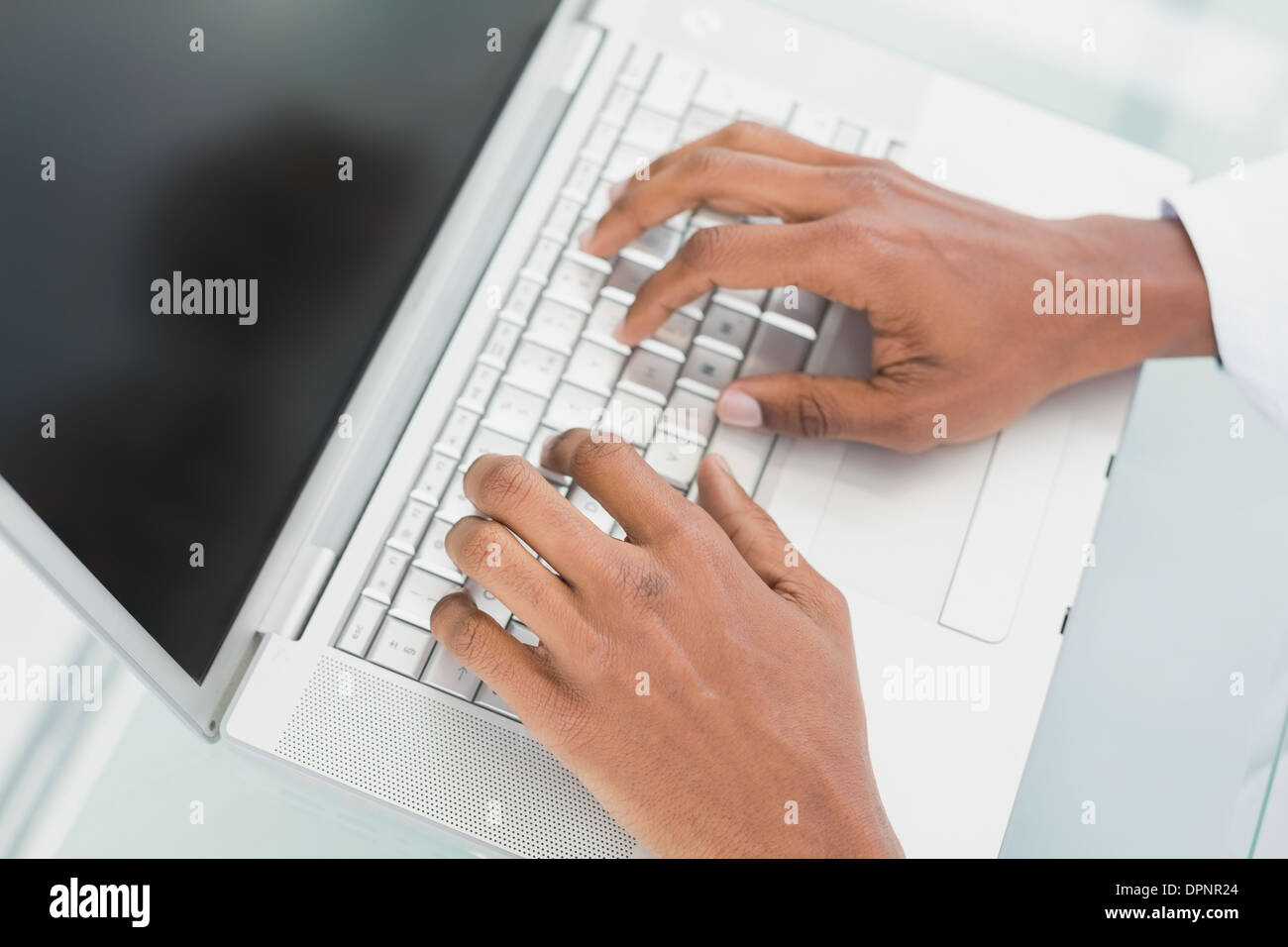 Hands using laptop at medical office Stock Photo - Alamy