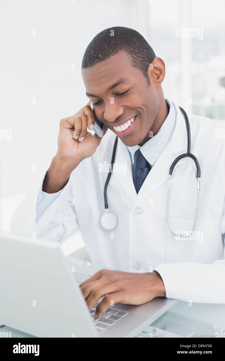 Male doctor typing on laptop hi-res stock photography and images - Alamy