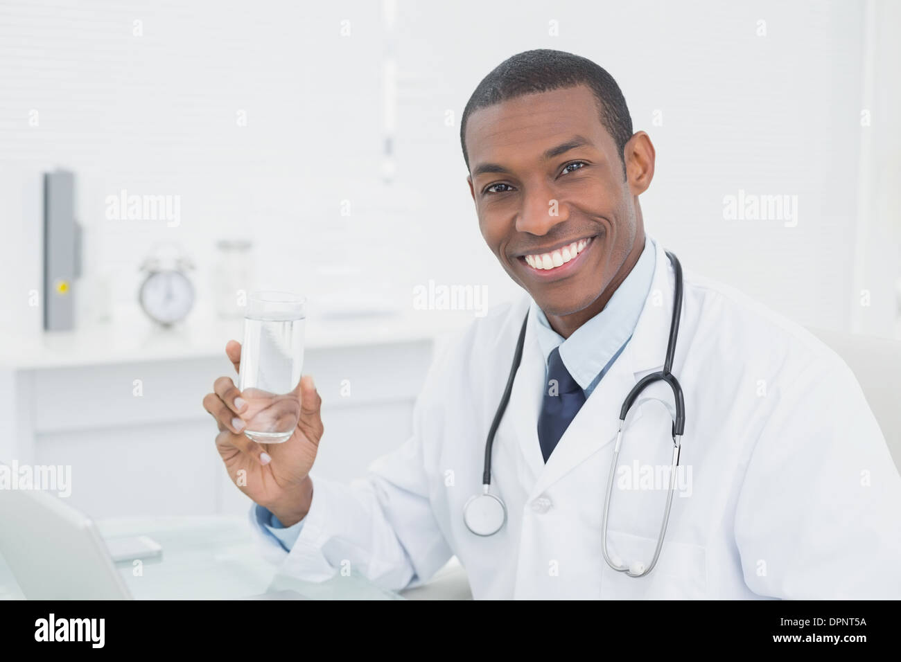 Black male holding glass water hi-res stock photography and images - Alamy