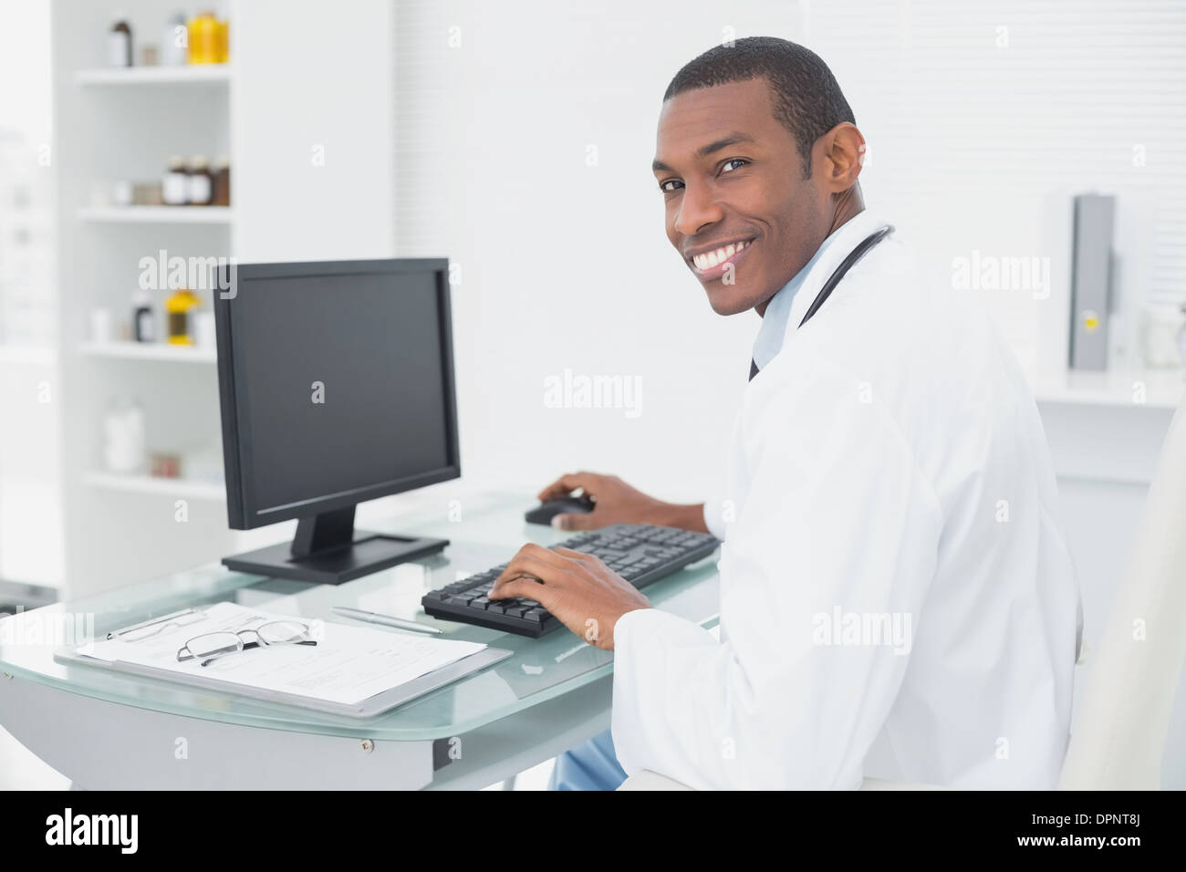 Happy handsome medical doctor typing hi-res stock photography and ...