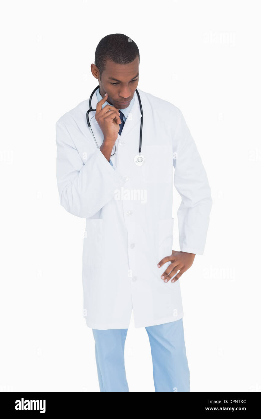 Serious thoughtful male doctor looking down Stock Photo - Alamy