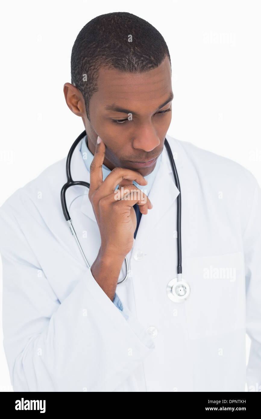 Serious thoughtful male doctor looking down Stock Photo - Alamy