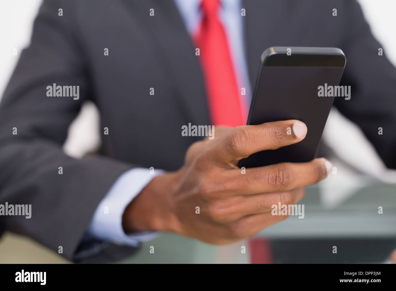 Mid adult businessman text messaging hi-res stock photography and ...