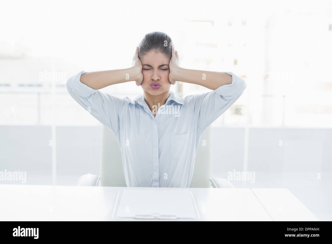 Businesswoman suffering from headache at office Stock Photo - Alamy
