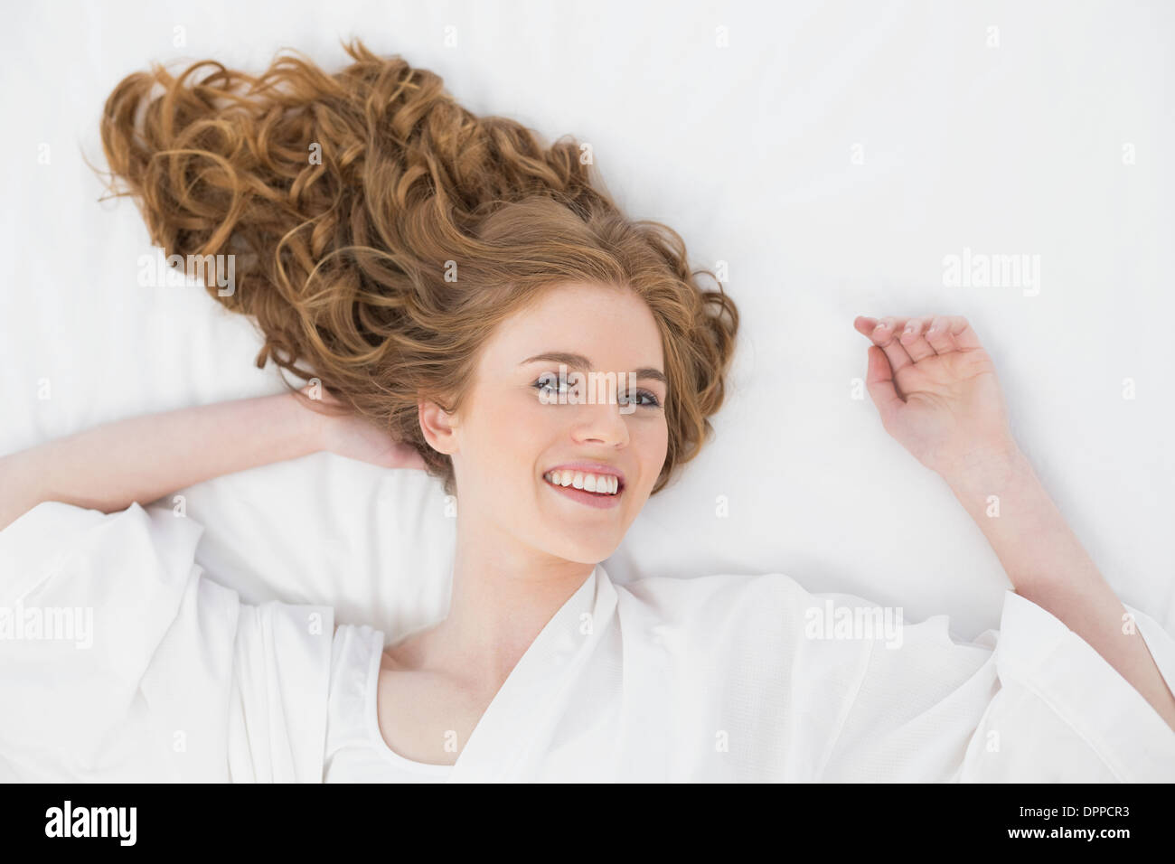 Overhead portrait of a smiling young blond in bed Stock Photo - Alamy
