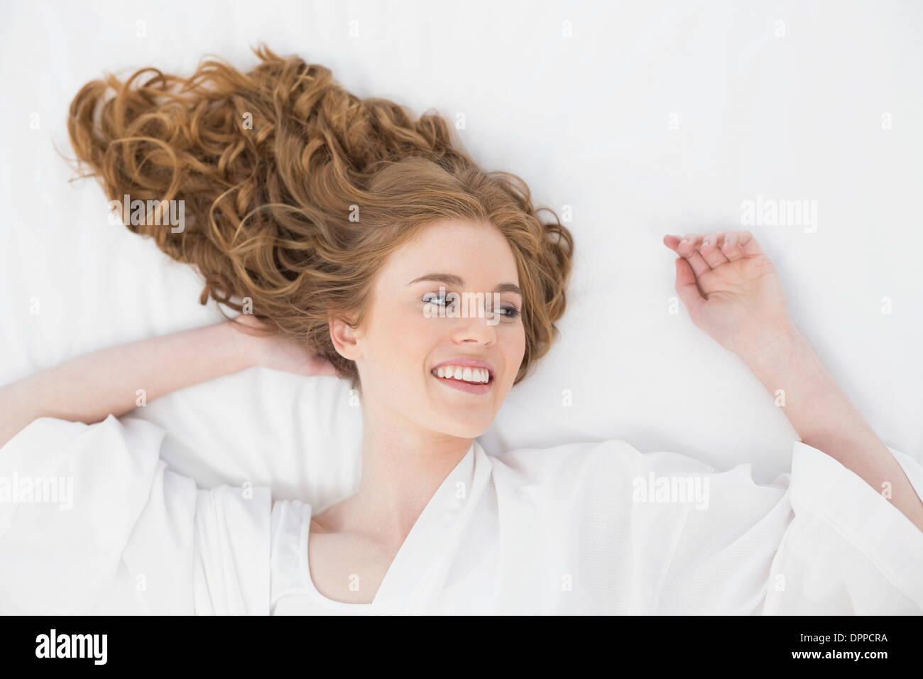 Overhead view of a smiling young blond in bed Stock Photo - Alamy
