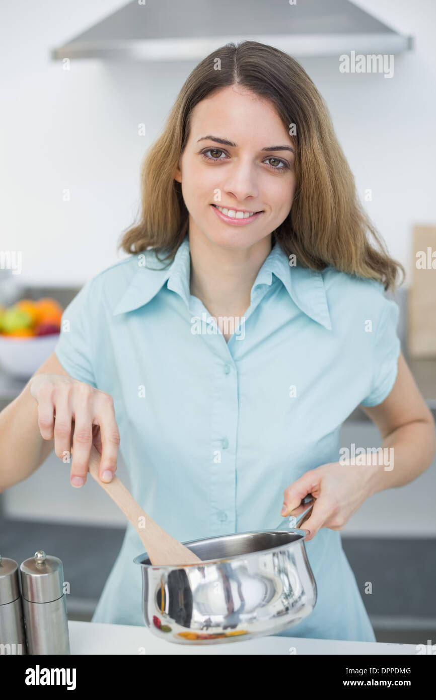 Calm beautiful woman cooking smiling at camera Stock Photo - Alamy