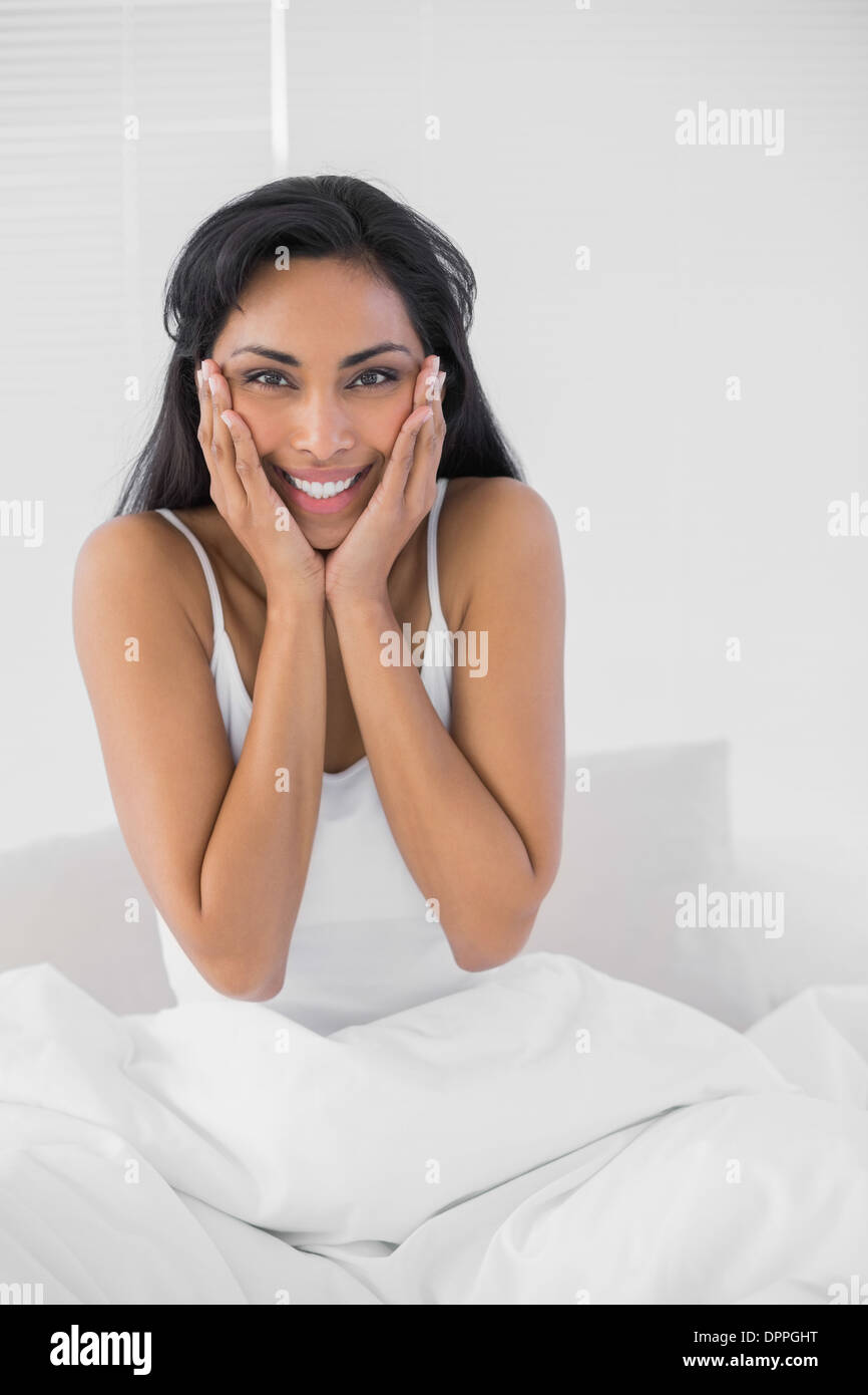 Gleeful dark haired woman posing smiling at camera Stock Photo - Alamy