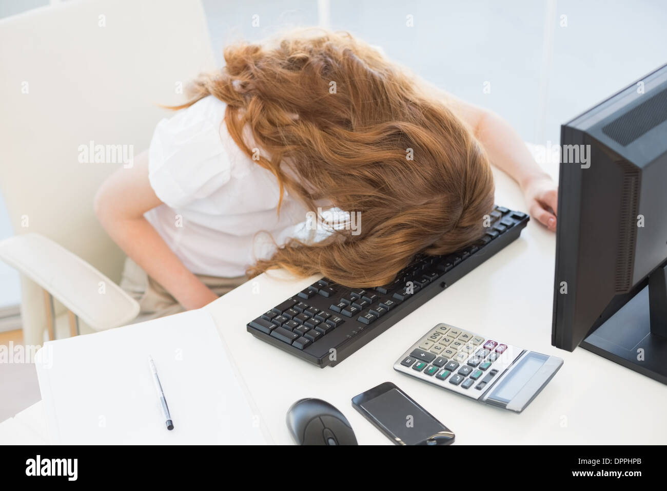 Businesswoman resting head on keyboard at office Stock Photo - Alamy