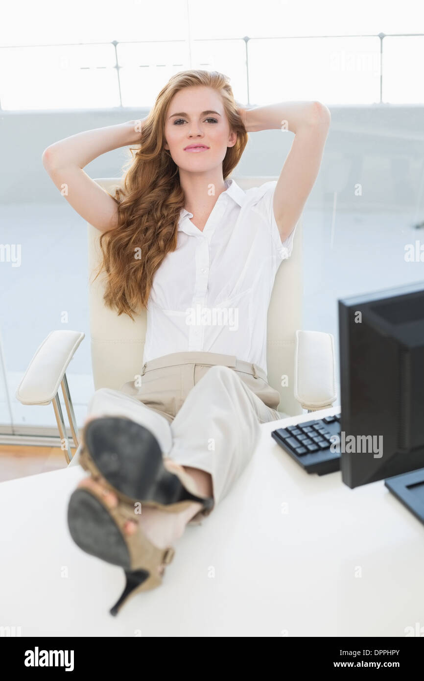 Relaxed businesswoman with legs on desk in office Stock Photo - Alamy