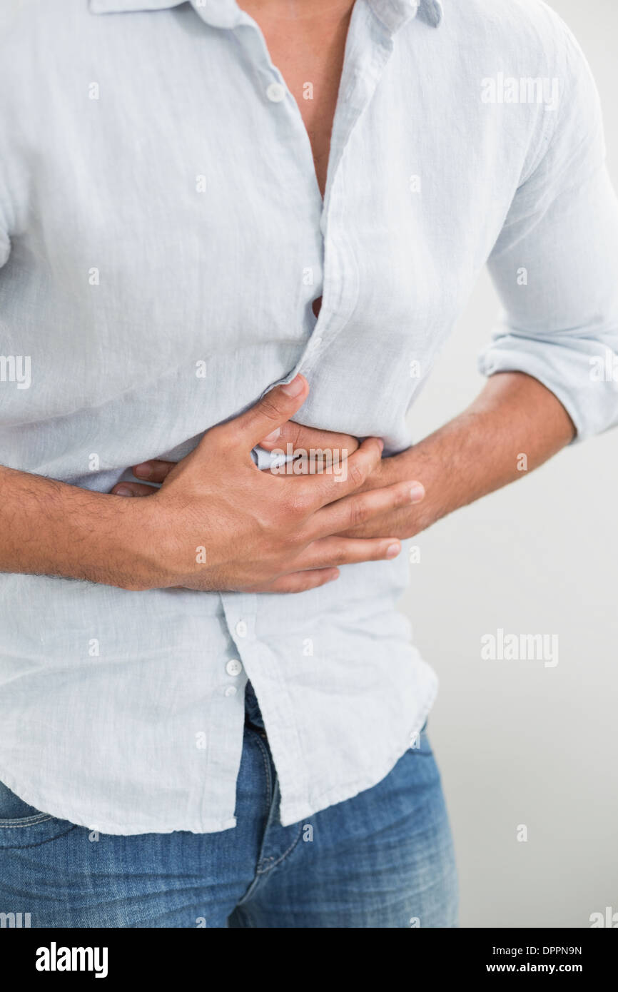 Mid section of man suffering from stomach pain Stock Photo - Alamy