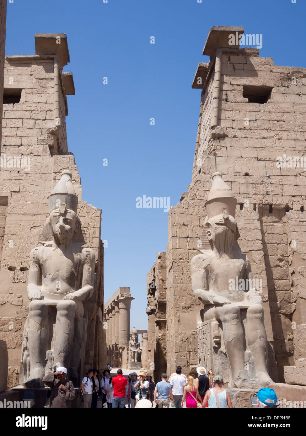 Two seated statues of Rameses II guard the huge pylon to the temple of ...