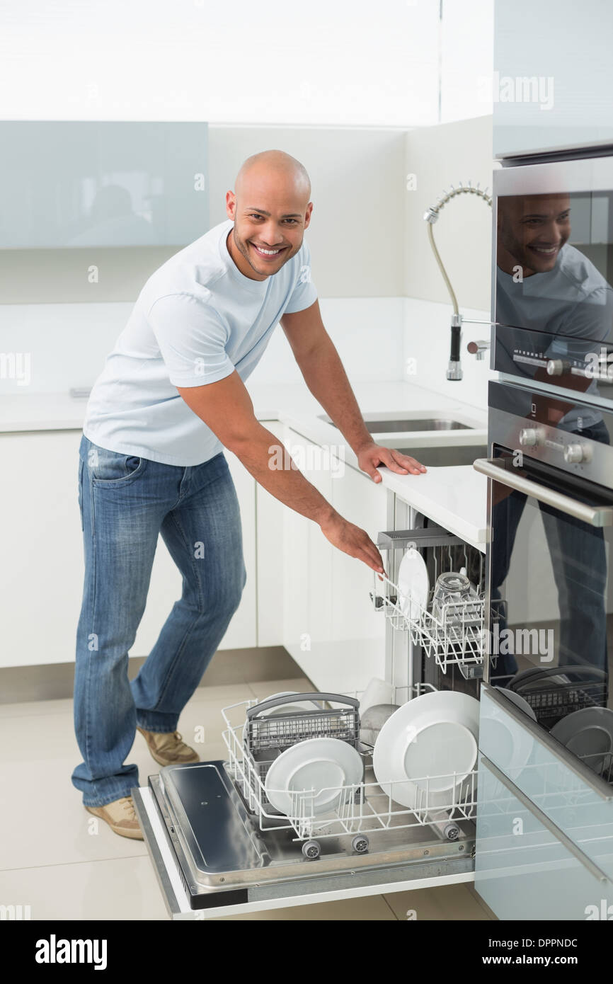 Young man washing dish in hi-res stock photography and images - Alamy