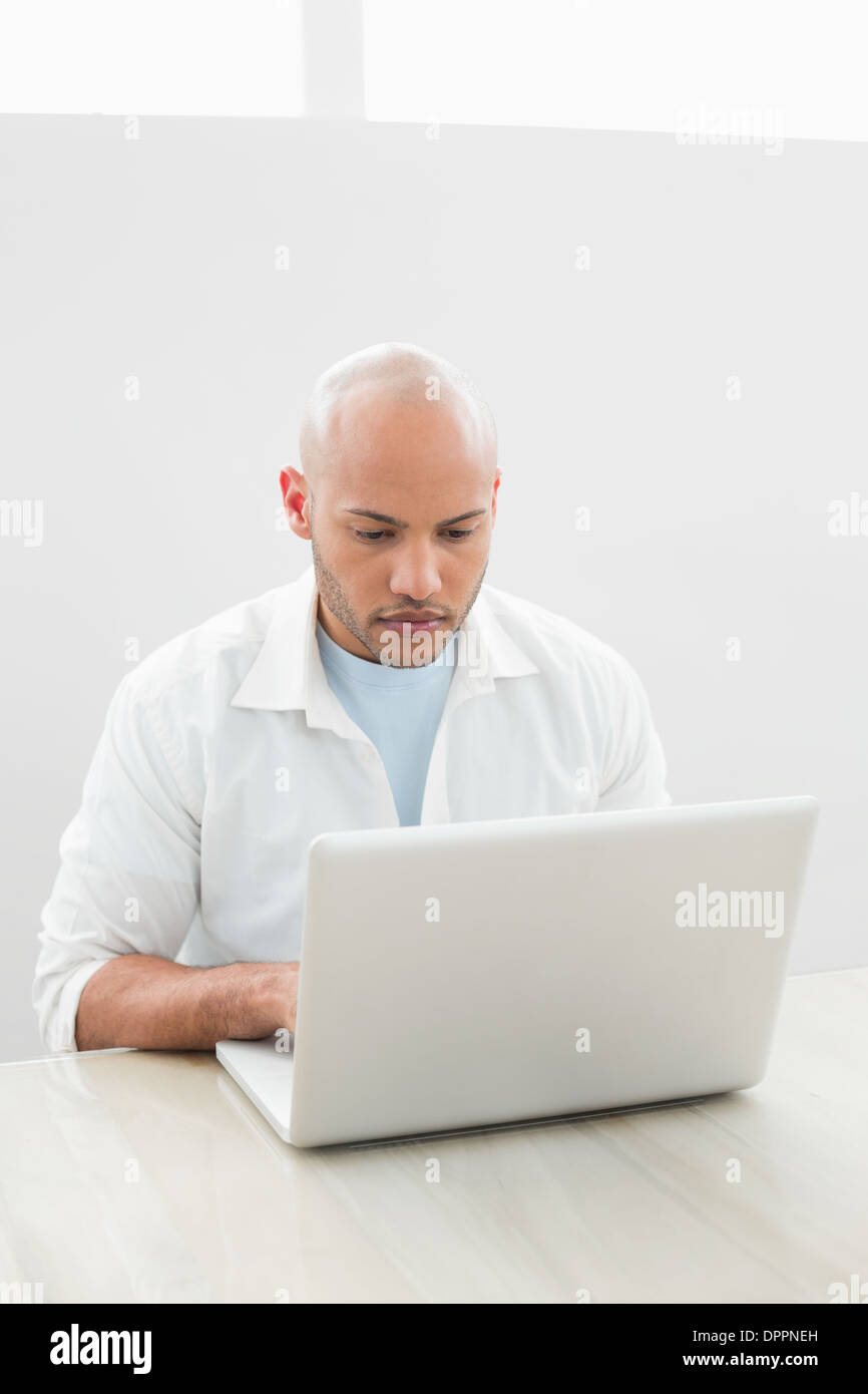 Serious young man using computer at hi-res stock photography and images ...