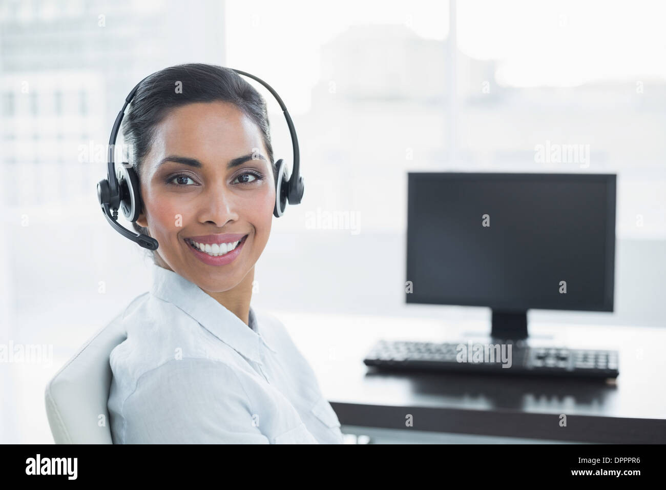 Content smiling agent wearing a headset Stock Photo - Alamy
