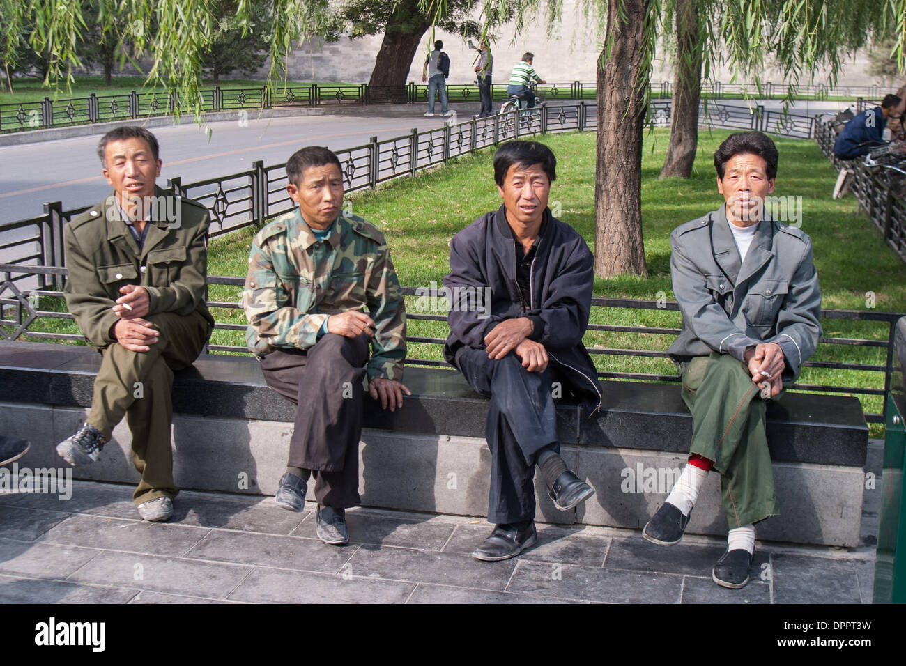 Beijing, China. 16th Oct, 2006. Four Chinese men sit on a park bench in ...