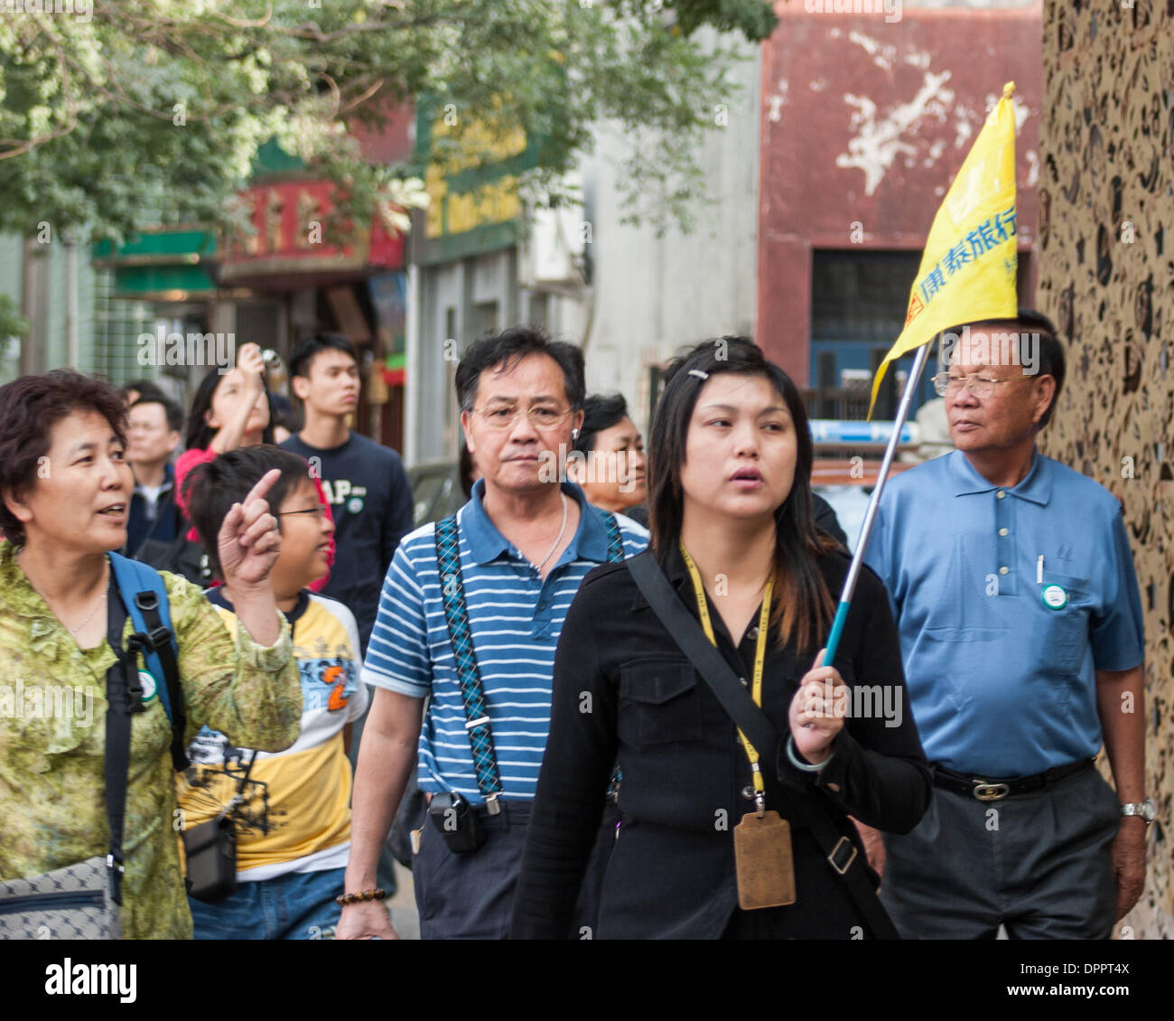 Beijing, China. 16th Oct, 2006. A Chinese tour guide, holding her ...