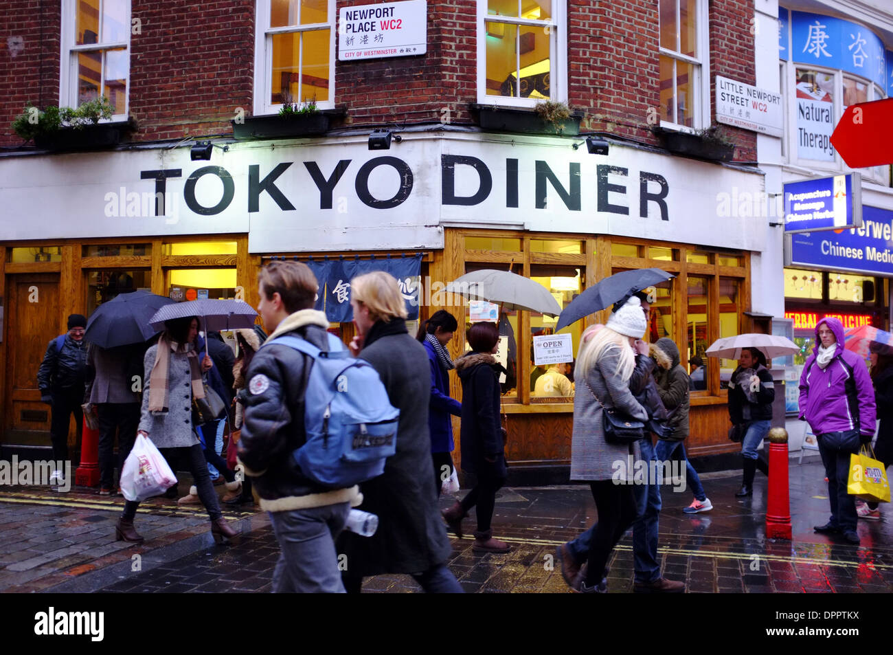 Tokyo Diner in Soho, with crowds walking past in rainy weather Stock ...