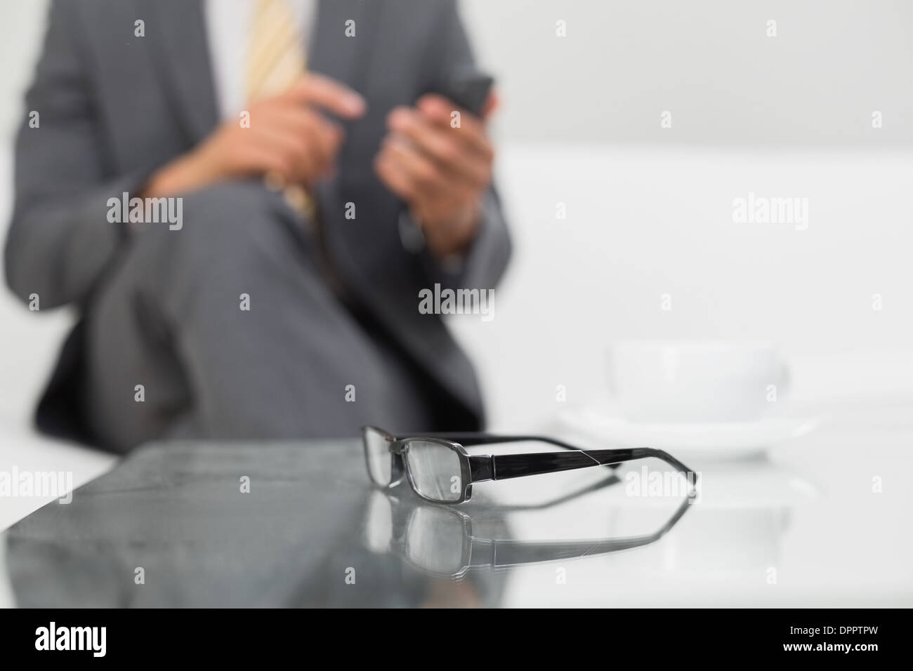 Mid adult businessman text messaging hi-res stock photography and ...