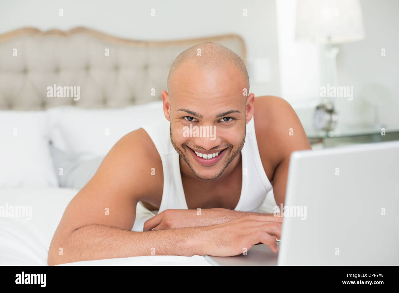 Man lying laptop smiling camera hi-res stock photography and images - Alamy