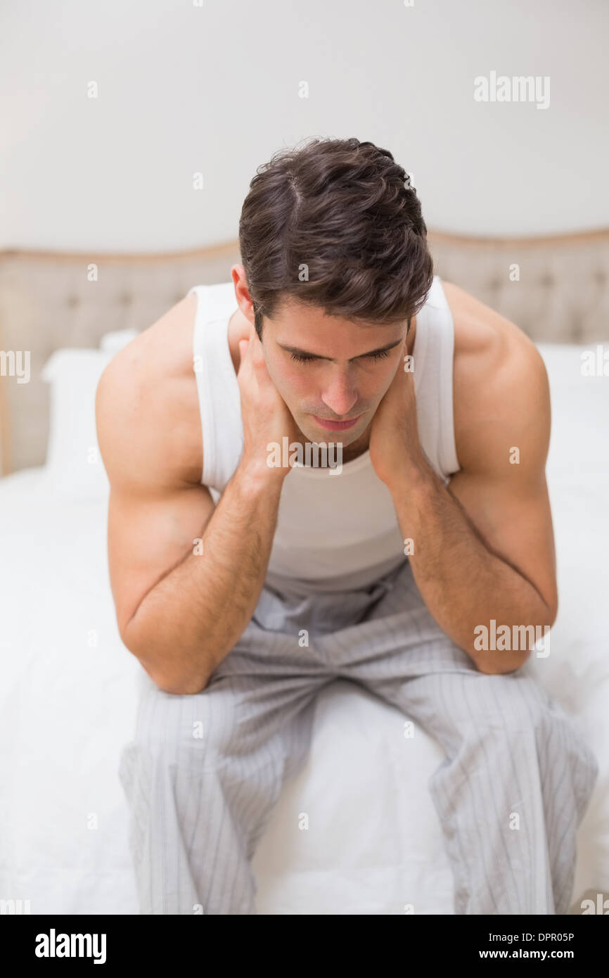 Young man in bedroom sitting hi-res stock photography and images - Alamy
