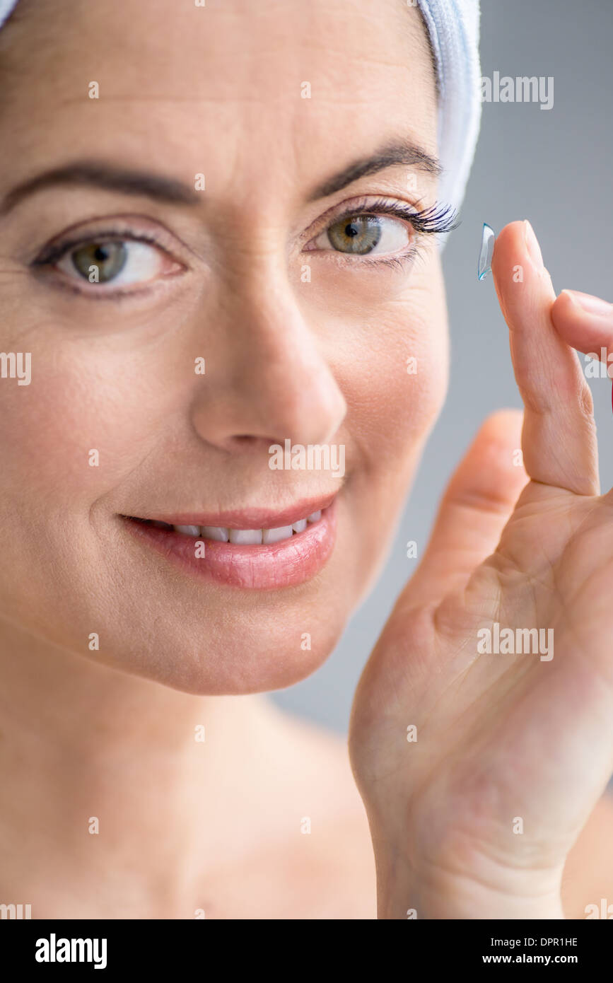 woman in her forties inserting contact lenses Stock Photo - Alamy