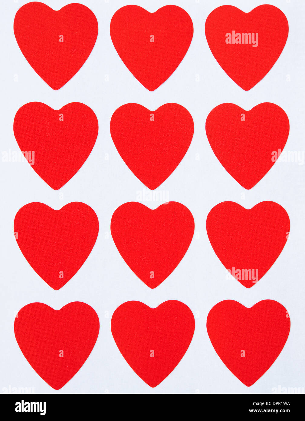 dozen of red hearts on the paper as background Stock Photo - Alamy