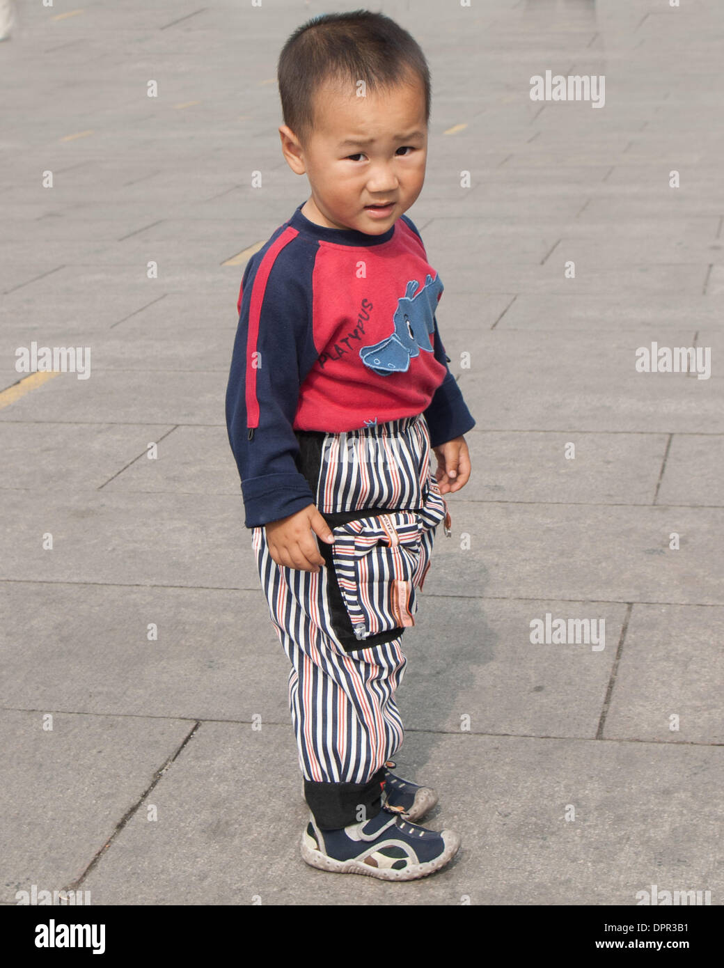 Beijing, China. 16th Oct, 2006. A young Chinese boy stands in Tienanmen ...