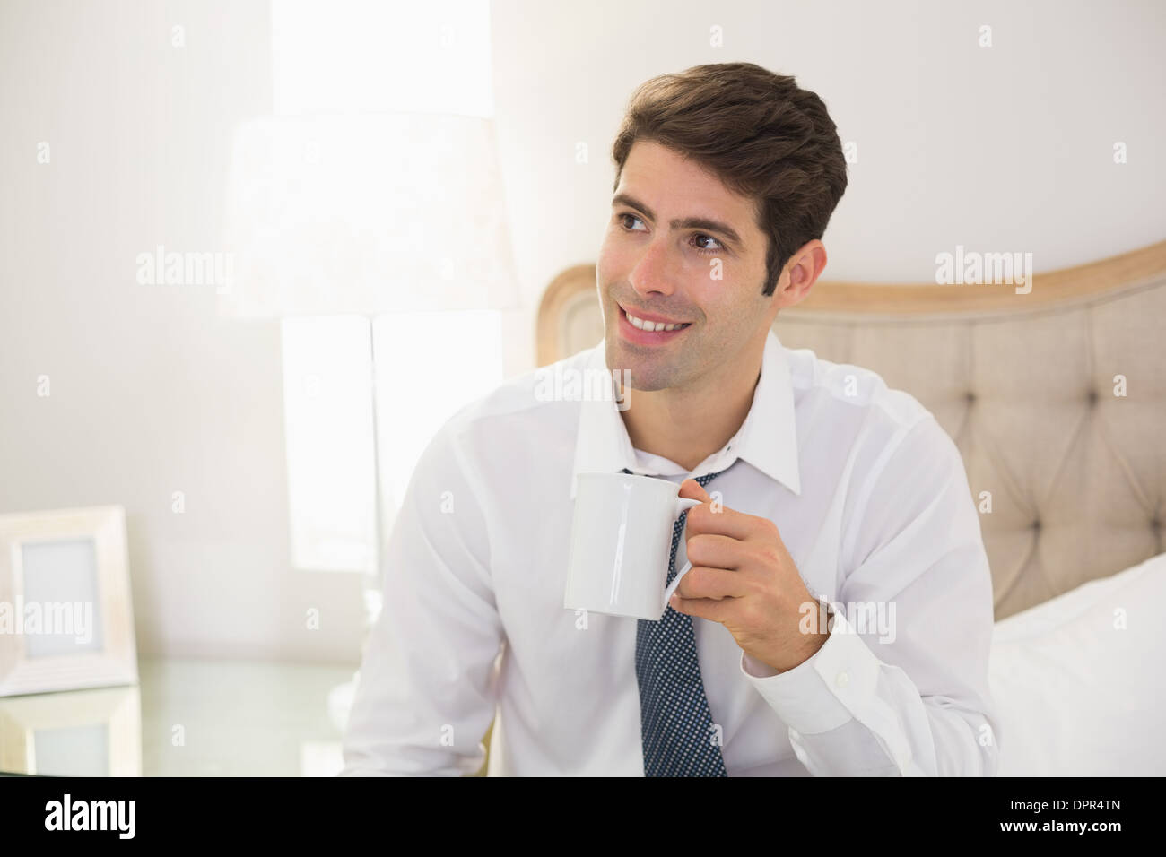 Smiling well dressed man drinking coffee in bed Stock Photo - Alamy Smiling well dressed man drinking coffee in bed Stock Photo - Alamy