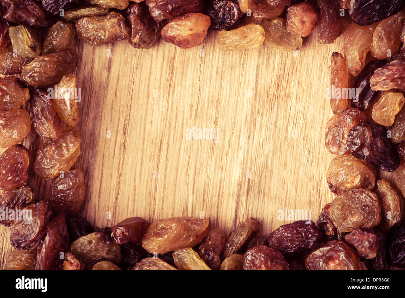 Healthy food organic nutrition. Border frame of raisin on wooden table ...