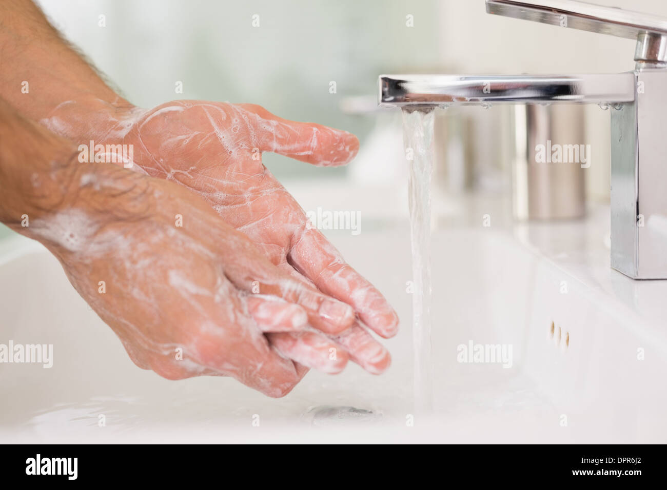 Washing hands with soap under running water Stock Photo - Alamy