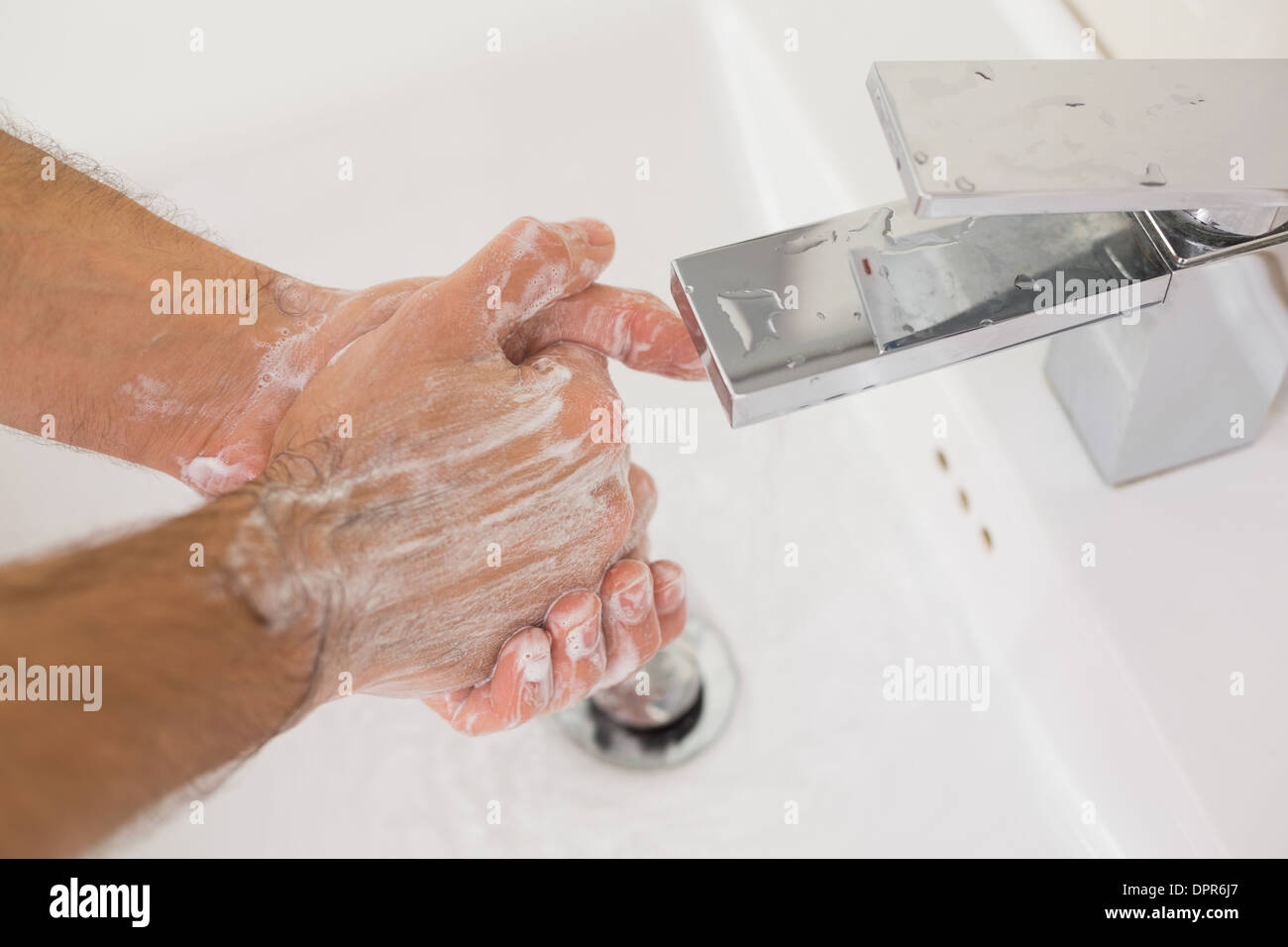 Washing hands with soap under running water Stock Photo - Alamy