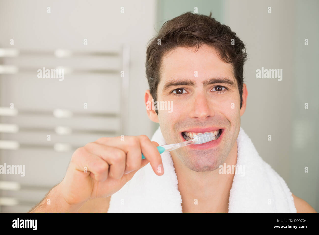 Close up portrait of man brushing teeth in bathroom Stock Photo - Alamy