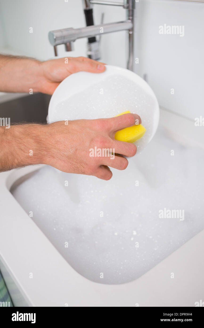 Hands washing dishes hi-res stock photography and images - Alamy