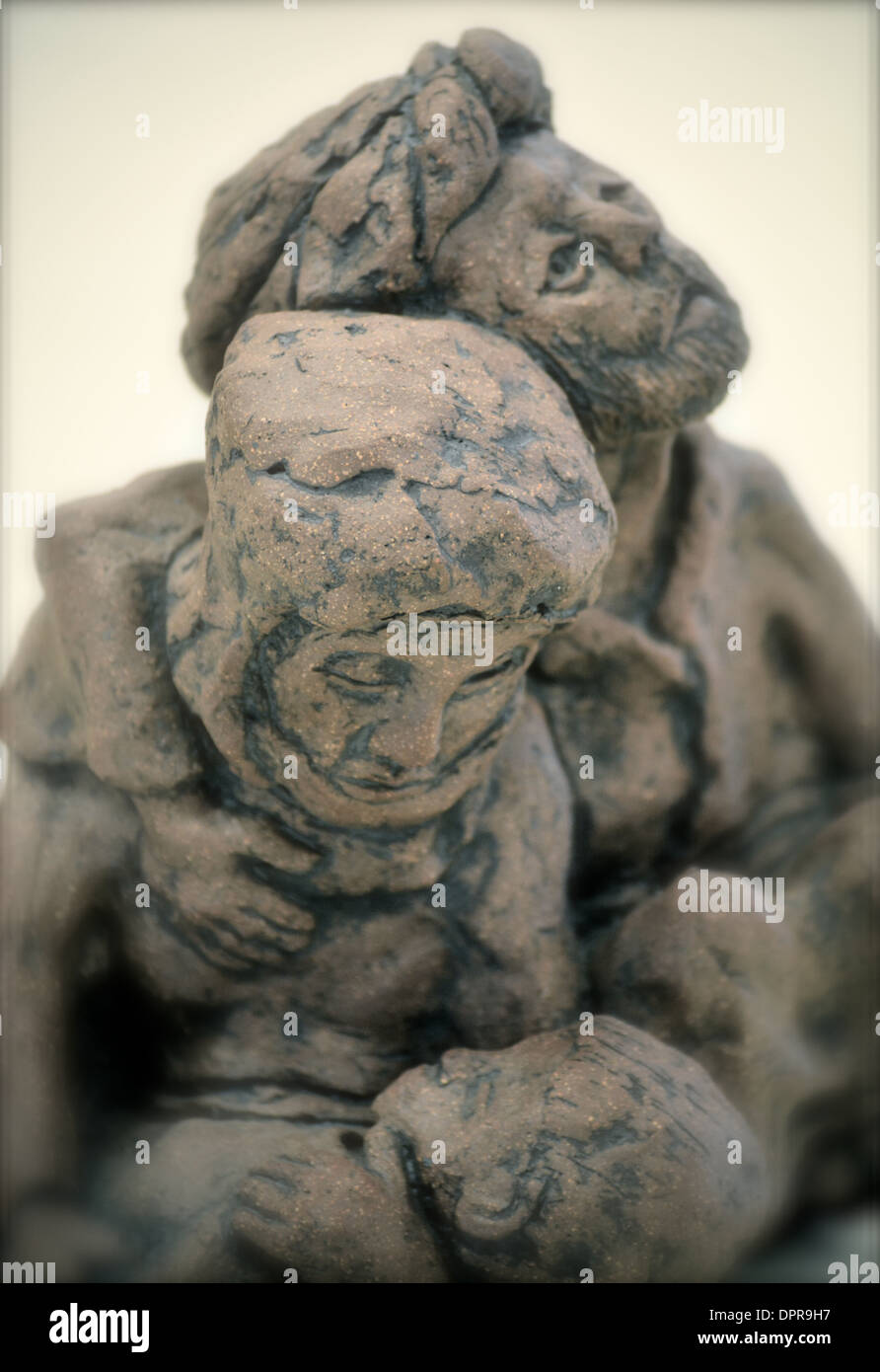 Figurine of two people comforting each other Stock Photo - Alamy