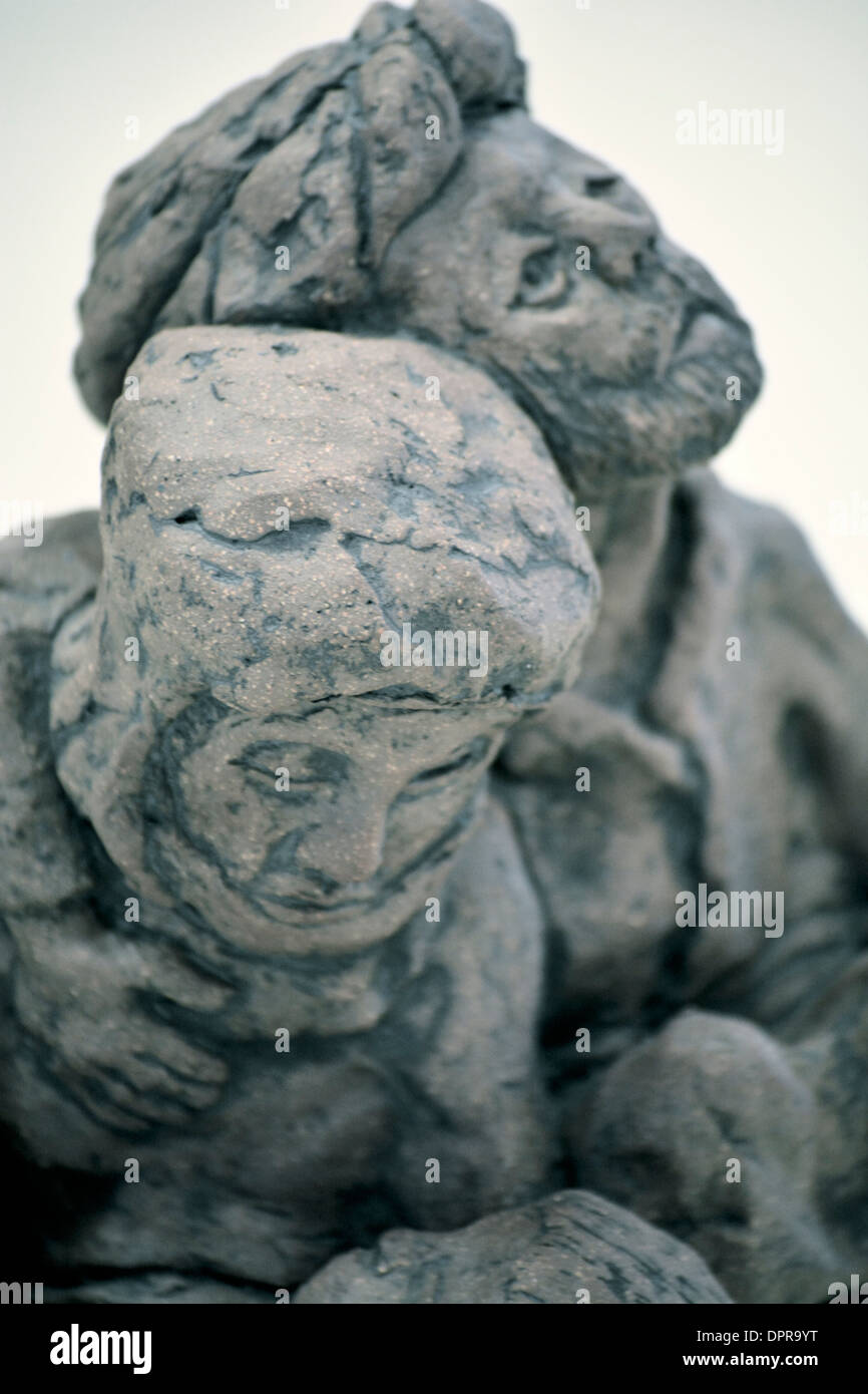 Figurine of two people comforting each other Stock Photo - Alamy