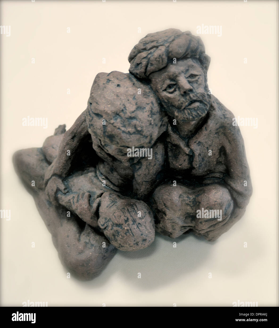 Figurine of two people comforting each other Stock Photo - Alamy