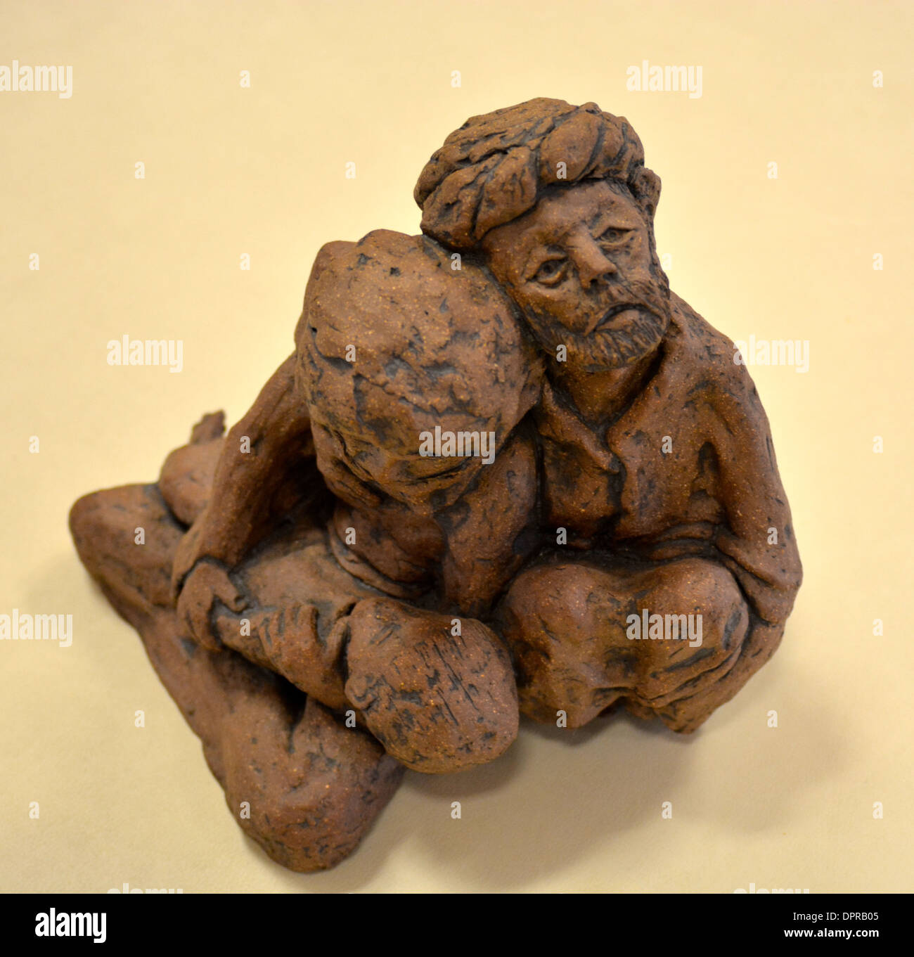 Figurine of two people comforting each other Stock Photo - Alamy