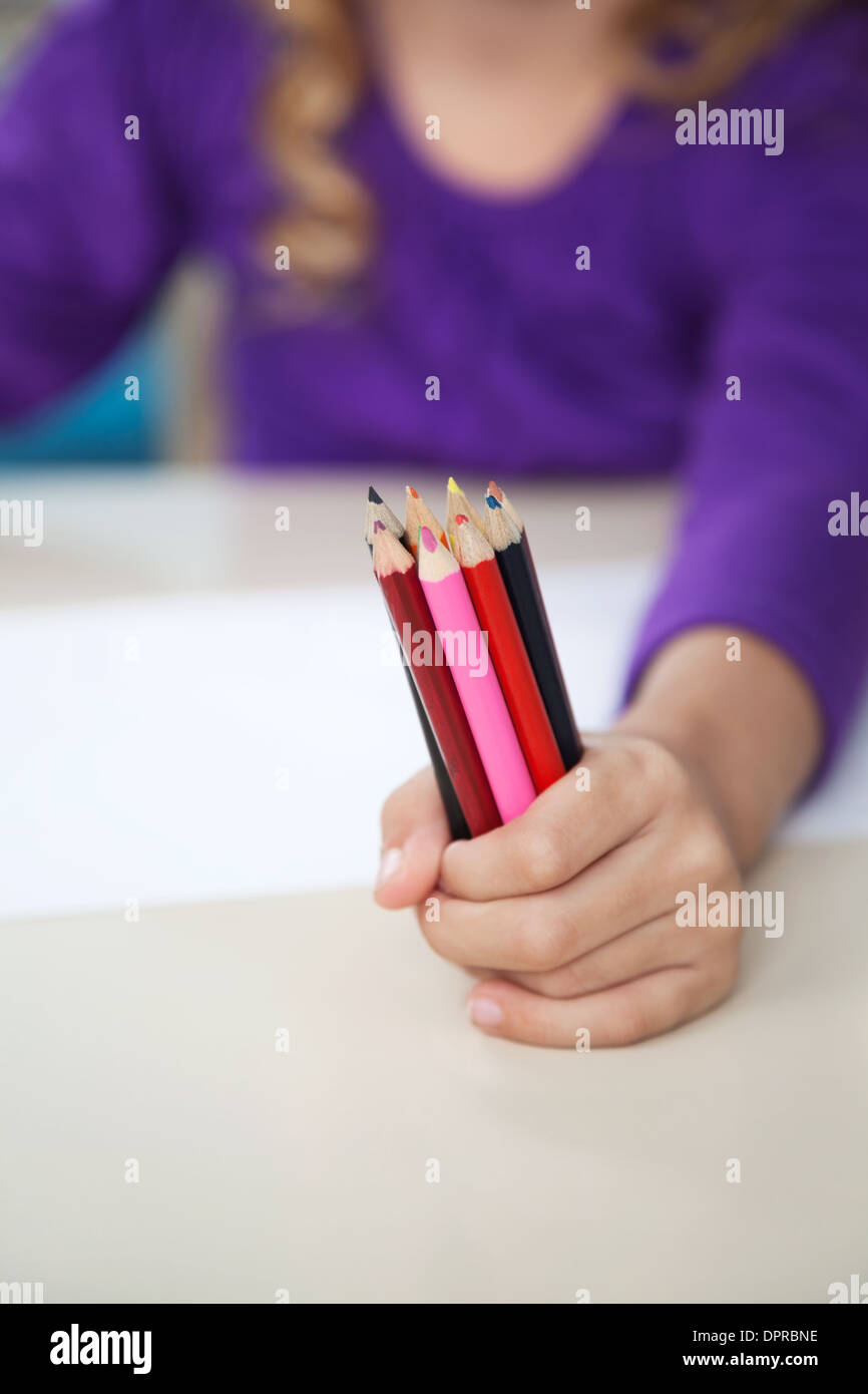 Girl holding colored pencils hi-res stock photography and images - Alamy
