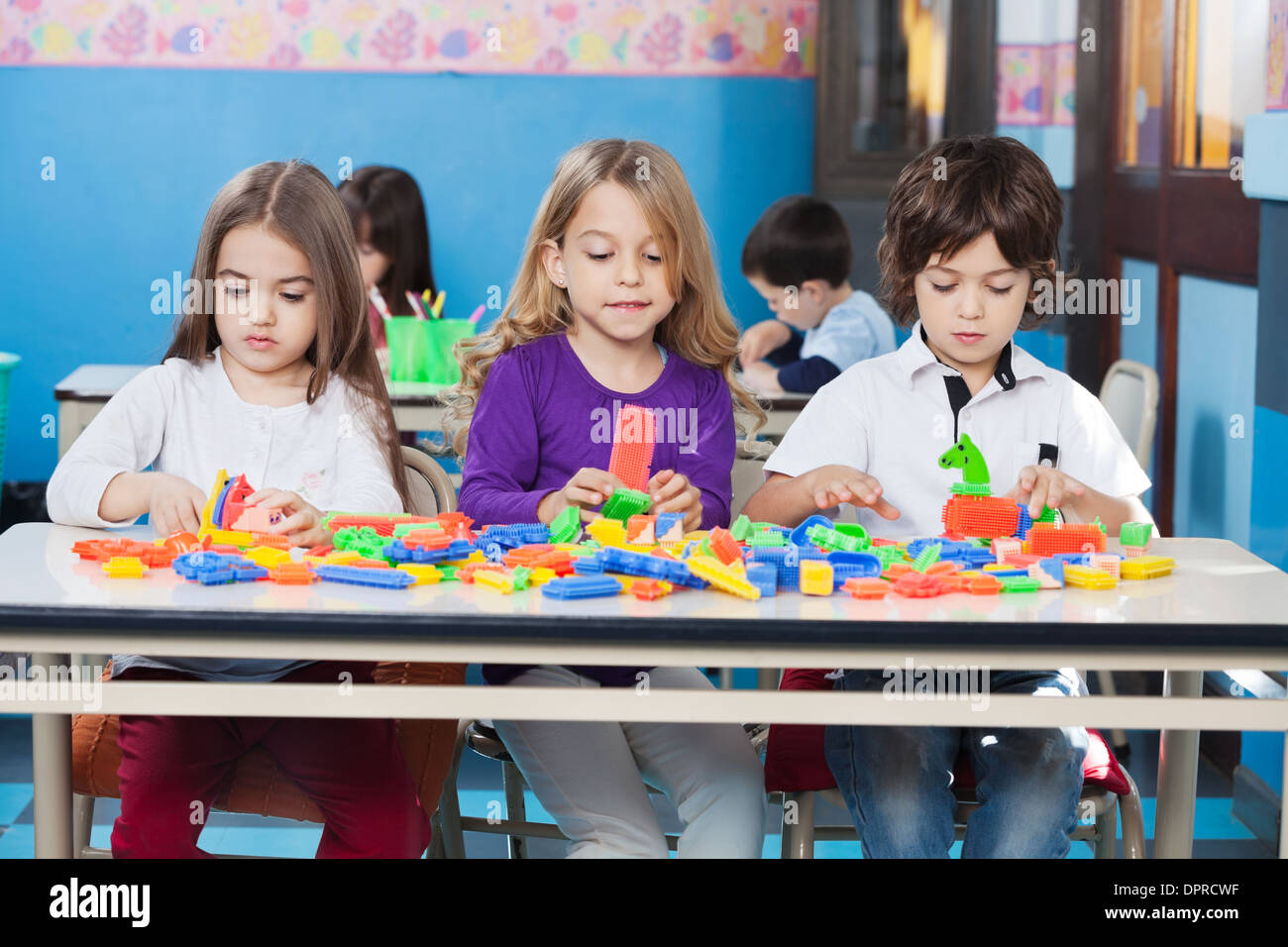 Children Playing With Construction Blocks In Classroom Stock Photo - Alamy