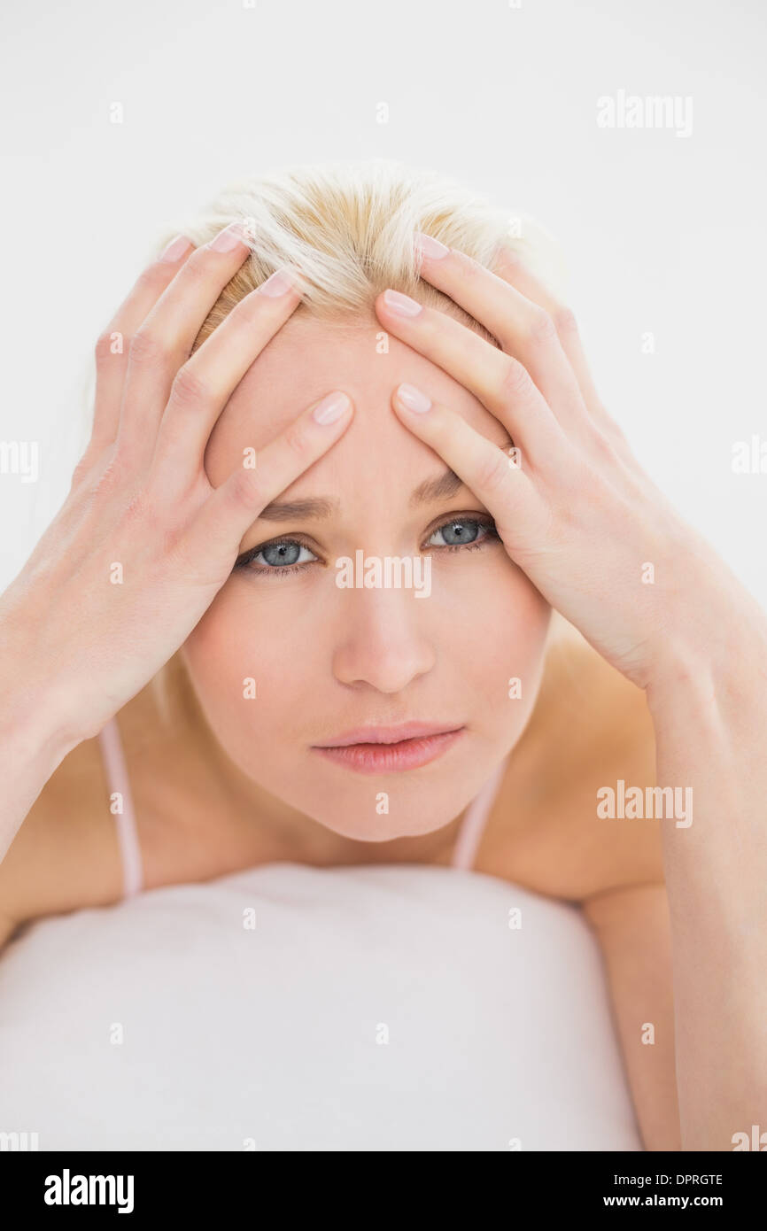 Close up of a tensed young woman in bed Stock Photo - Alamy