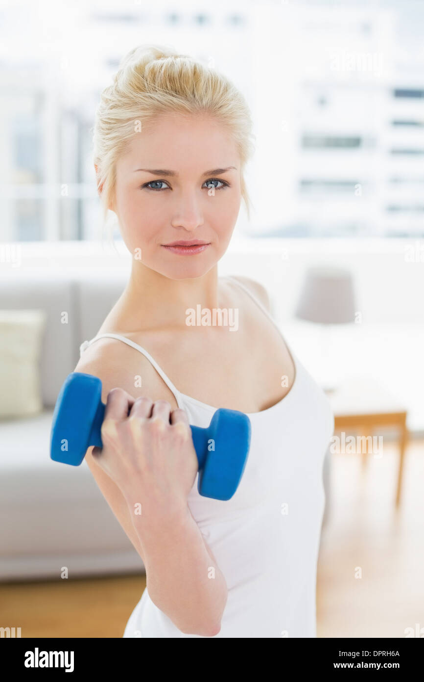 Serious woman with dumbbell at fitness studio Stock Photo - Alamy